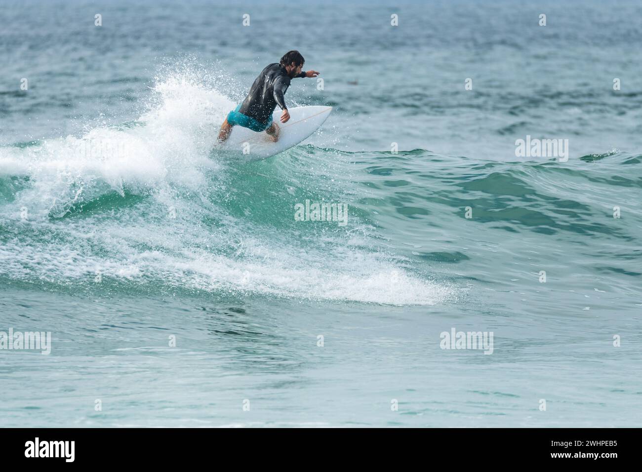 Local surfer riding waves Stock Photo - Alamy