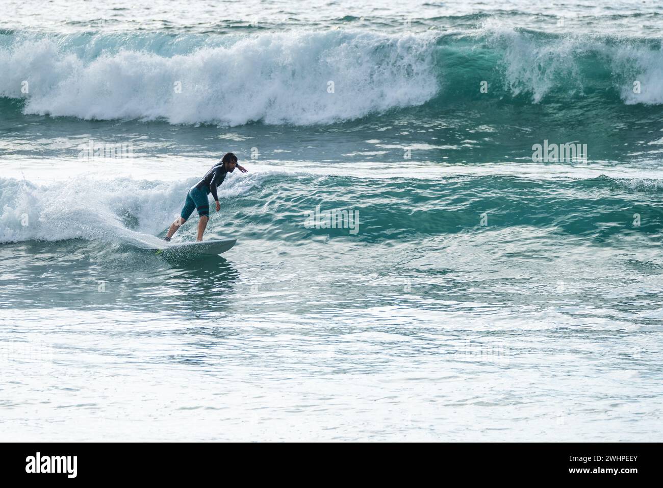 Local surfer riding waves Stock Photo - Alamy