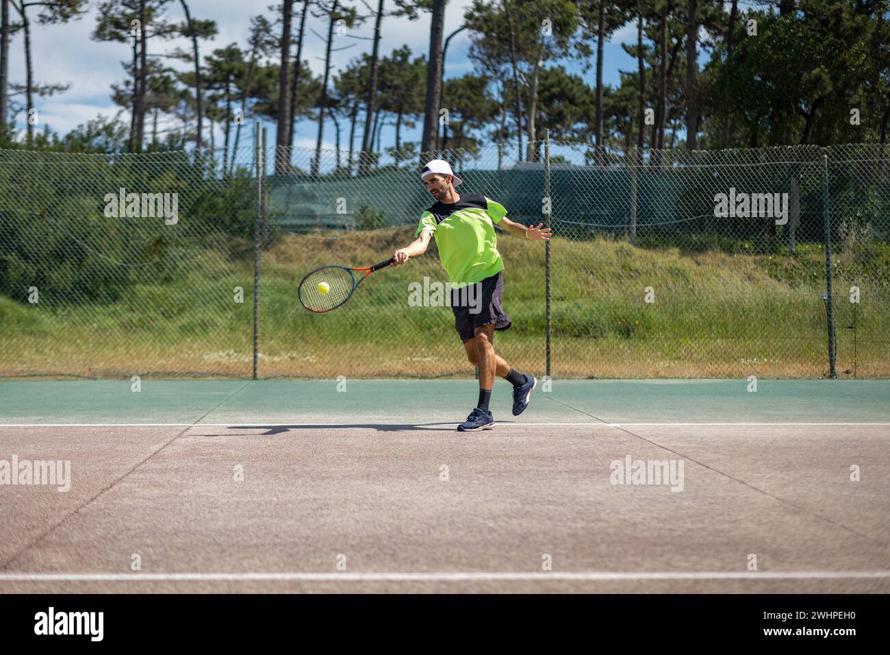 Tennis player hitting forehand at ball Stock Photo - Alamy