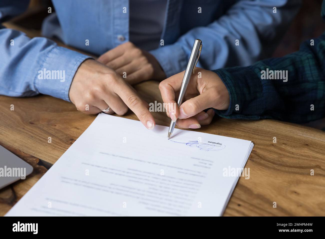 Female client and manager signing paper agreement, ending meeting Stock ...