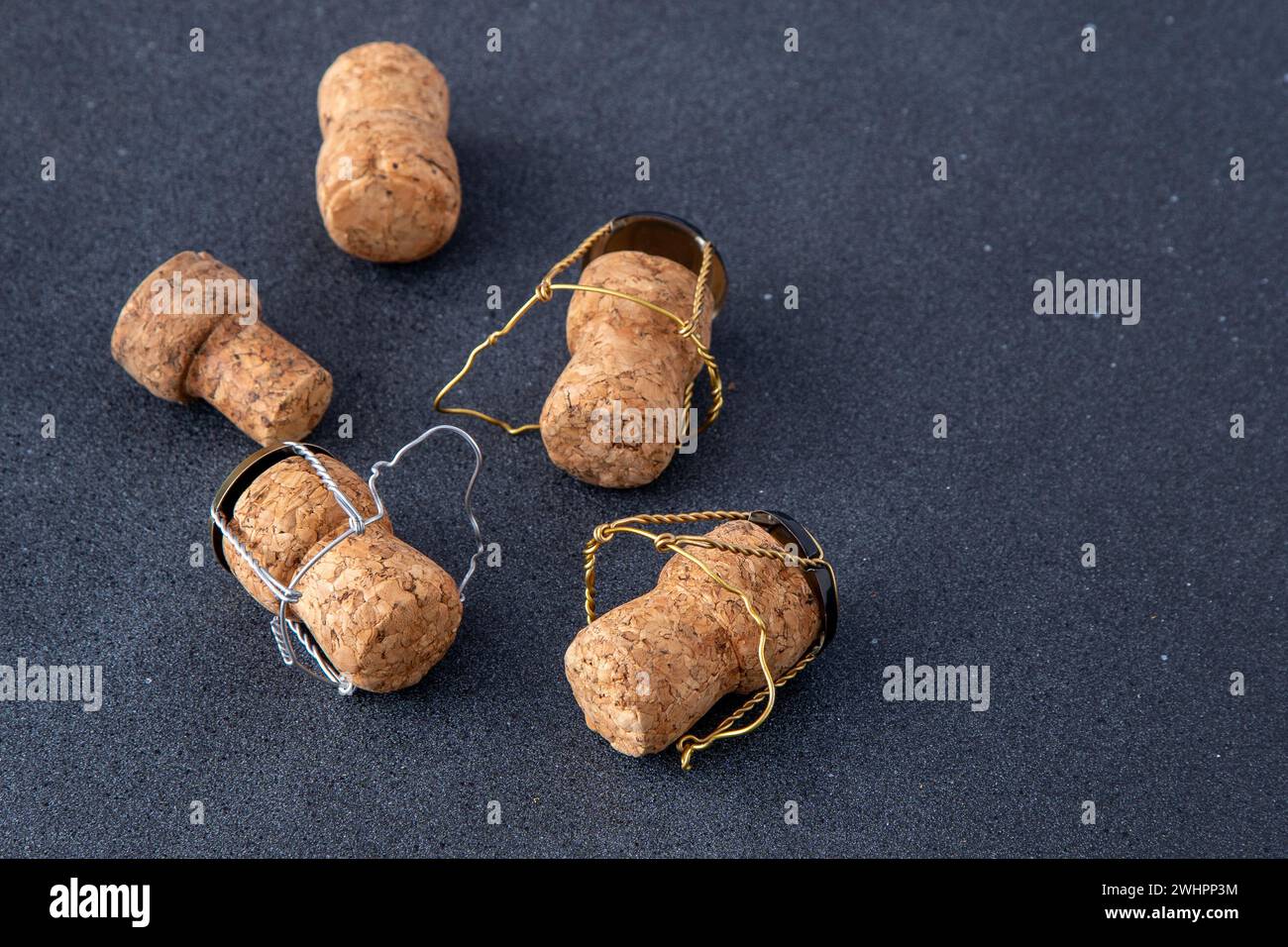 Champagne corks and metal mesh. Dark wine background Stock Photo - Alamy