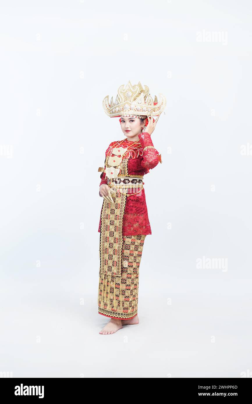 A female model wears traditional Lampung Pepadun clothing or can also ...