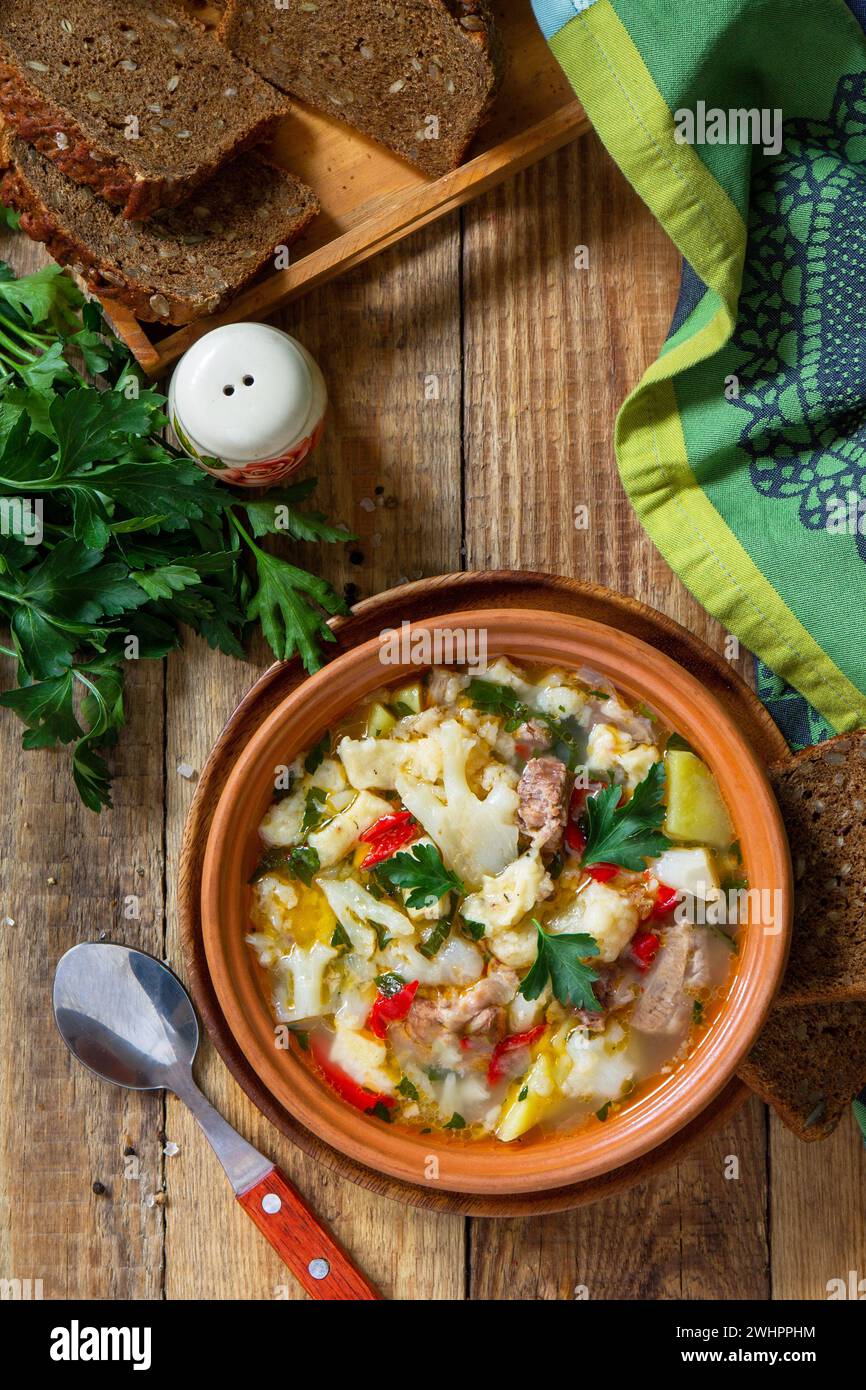 Traditional Hungarian thick soup with beef, vegetables and dumplings on ...
