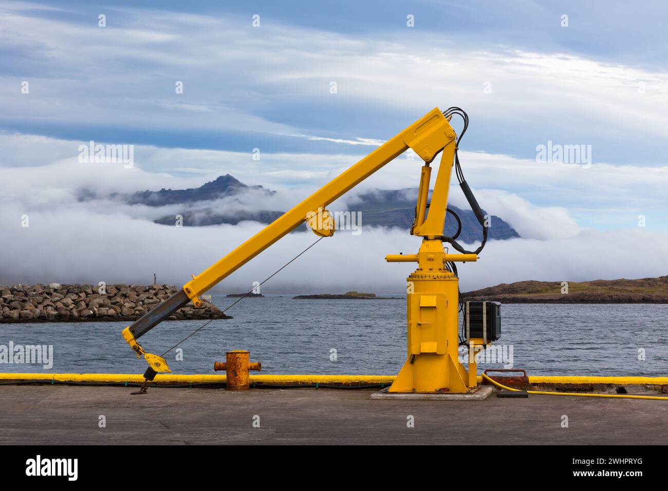 Fishing crane in small seaside Iceland town harbor Stock Photo - Alamy