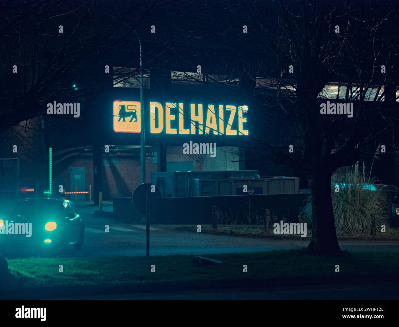 Brussels, Belgium 06-02-2024. Building facade with Delhaize night logo ...
