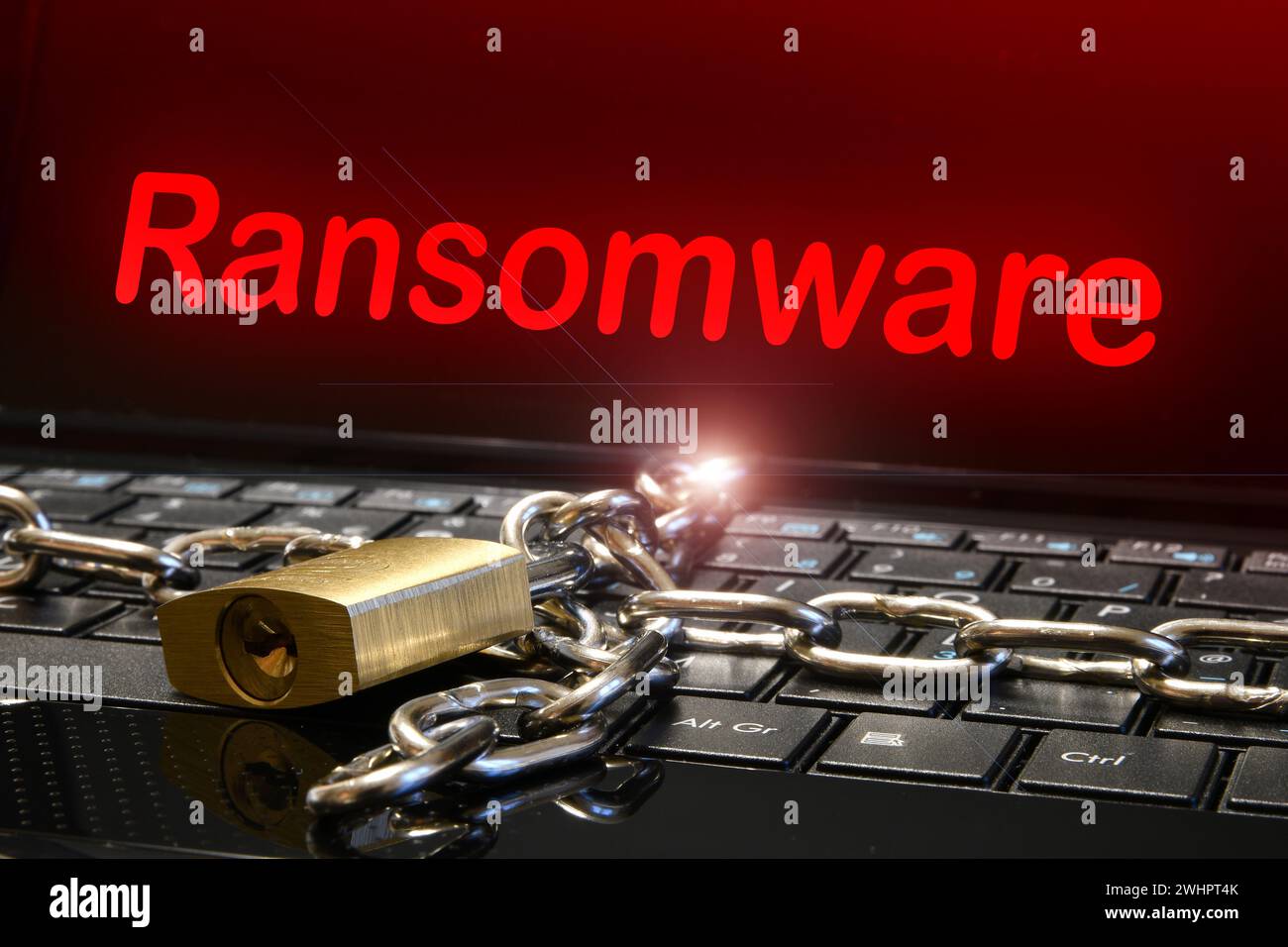 Computer security concept with an iron chain and padlock on the laptop keyboard and "Ransomware ...
