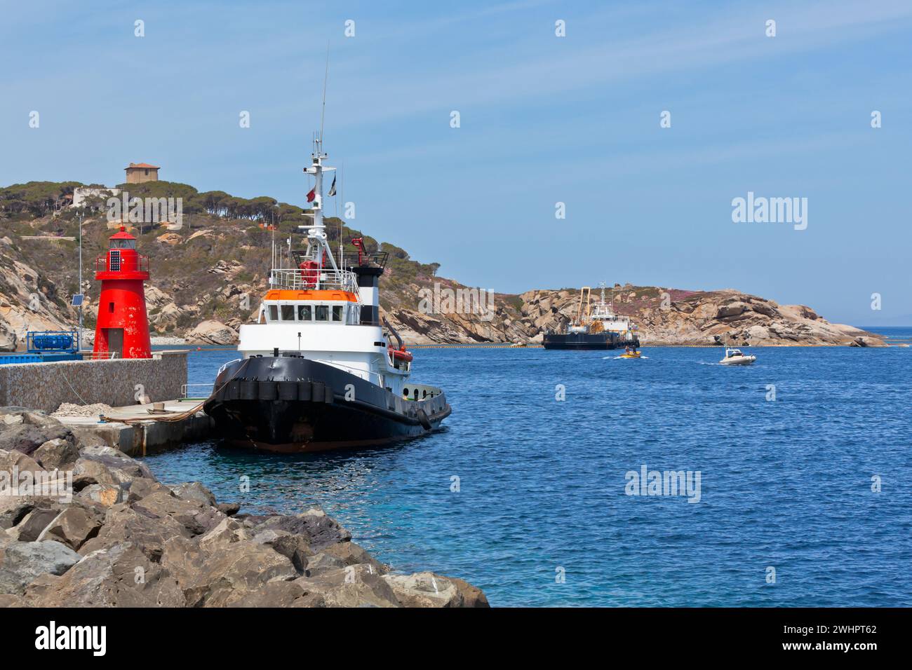 Fishing Trawlers and Small Red Lighthouse Stock Photo - Alamy