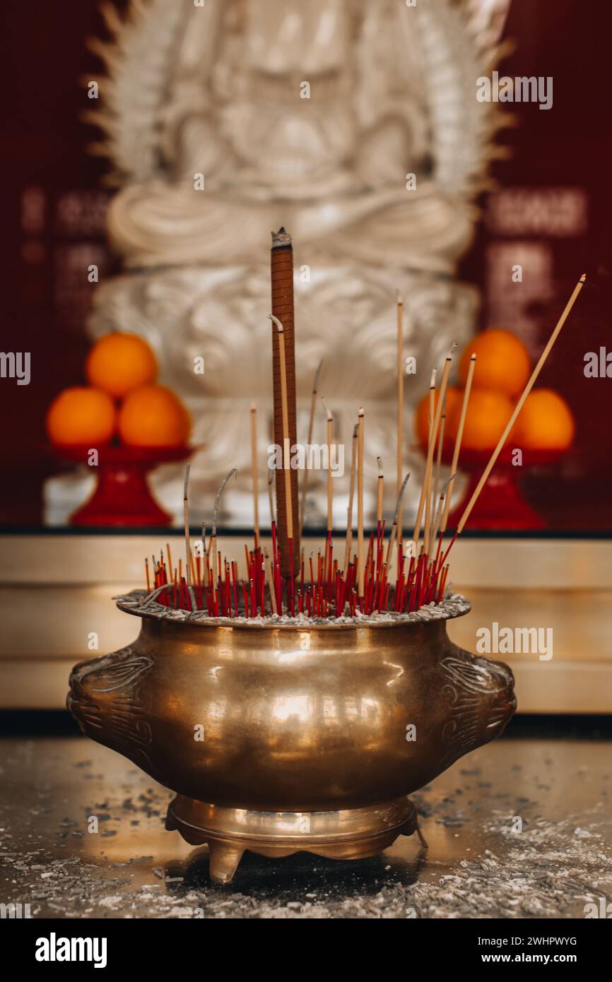 Burning incense in a golden vat in a Buddhist temple. Thai traditions ...
