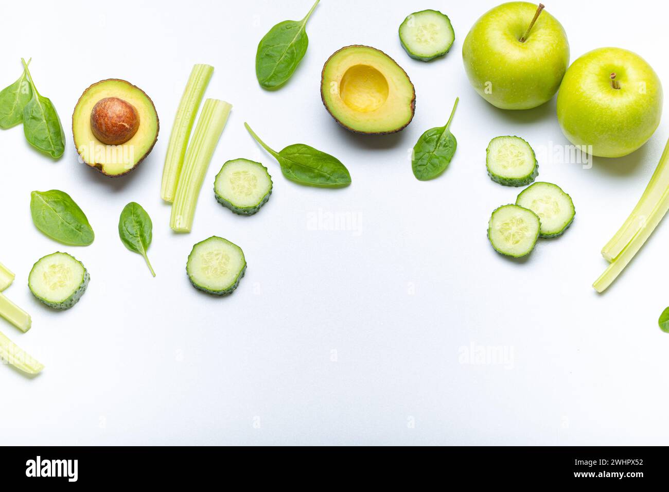 Healthy food border with green fresh vegetables and fruit on simple ...