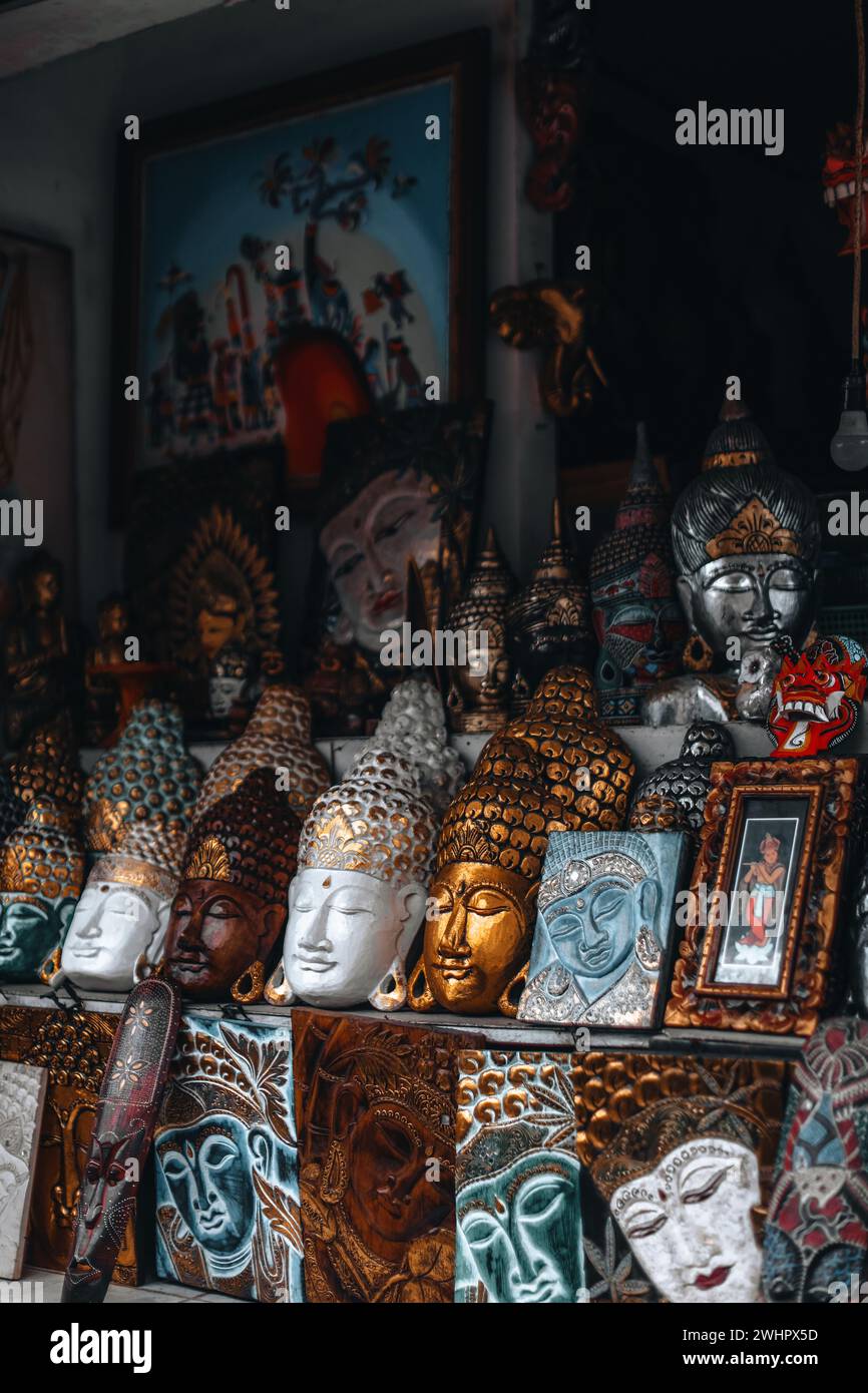 Golden and silver handmade gold plated Buddha face masks on a counter ...
