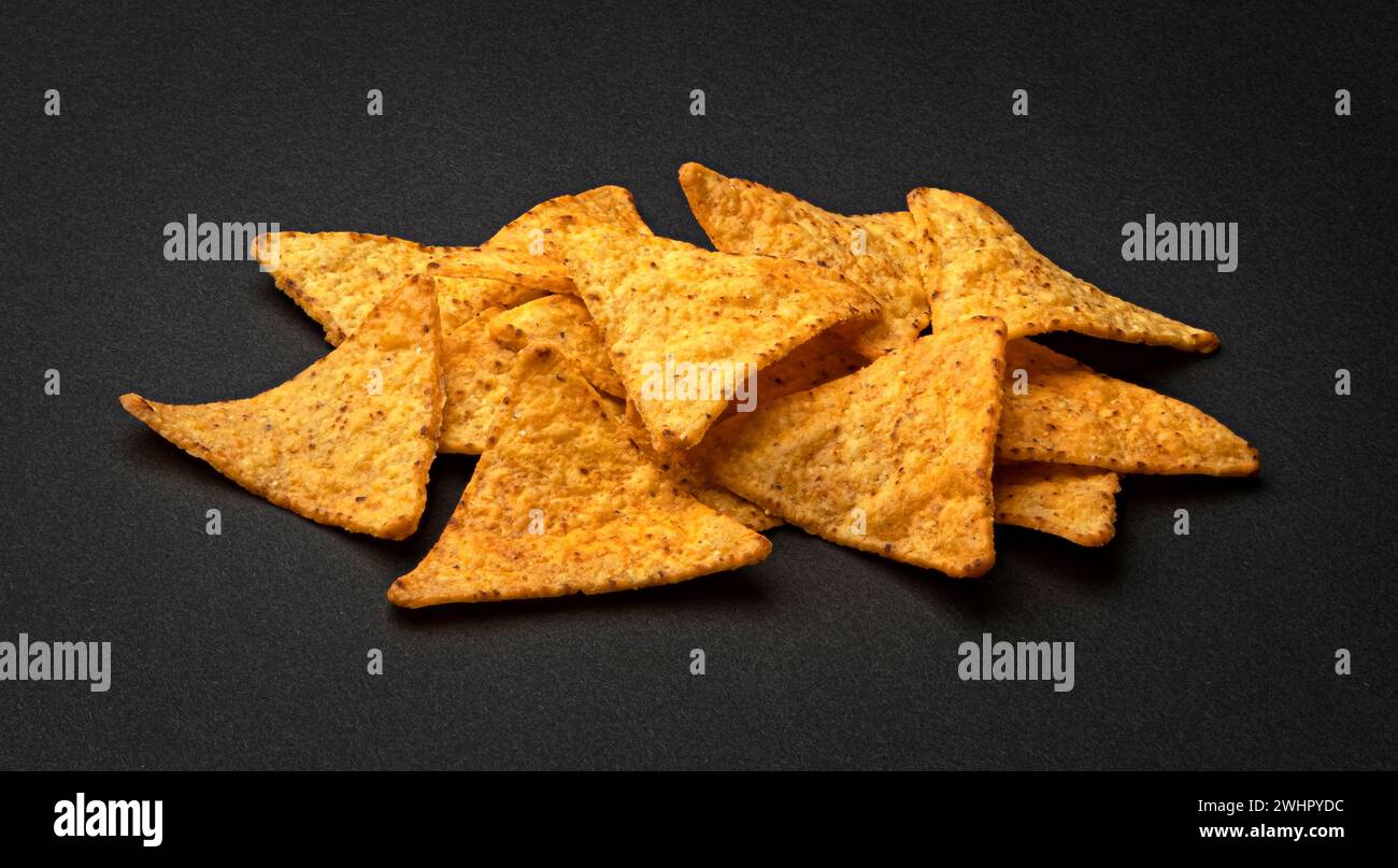 Spicy corn chips, hot Mexican nachos isolated on black background Stock ...