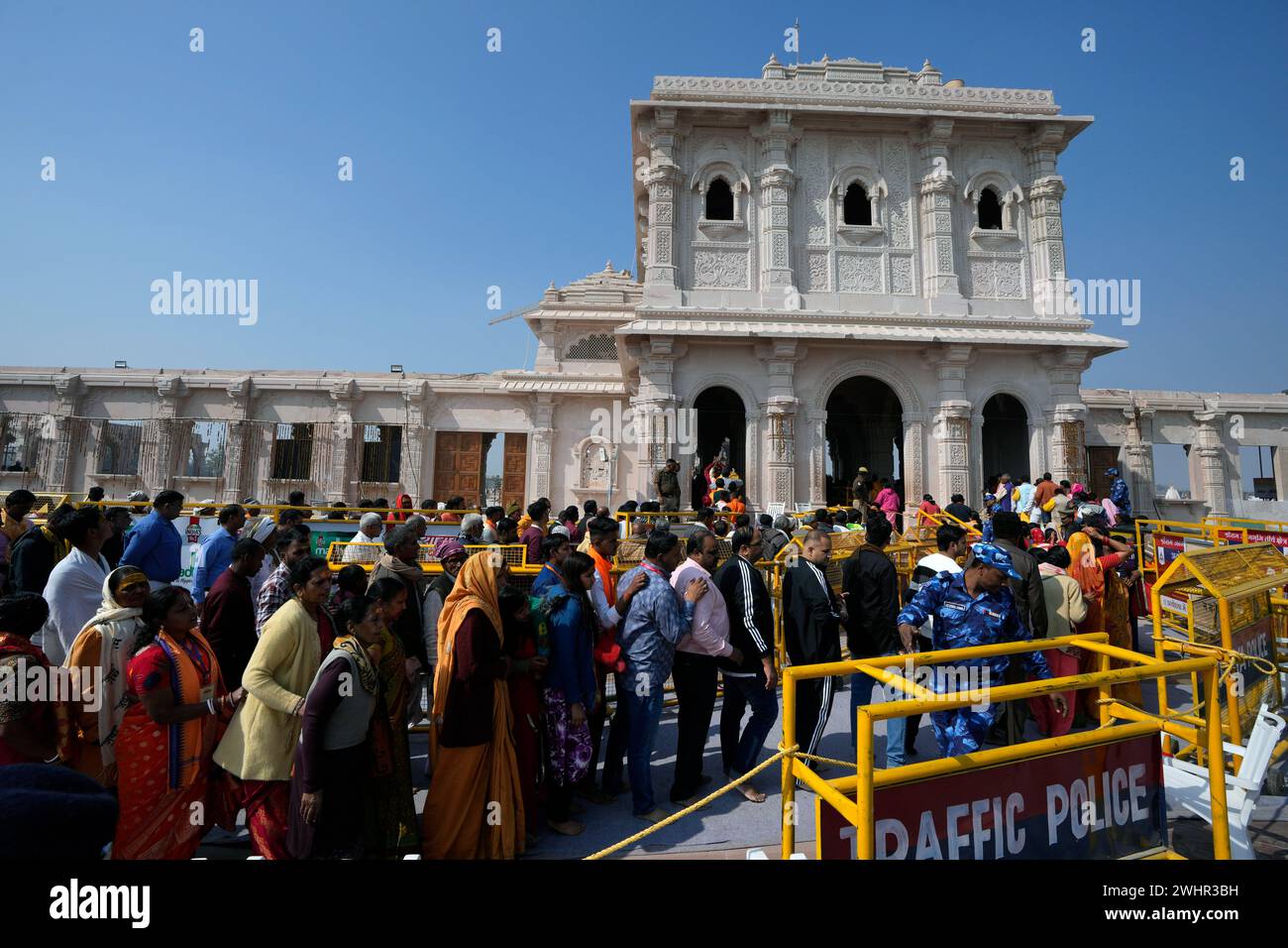 Devotees stand in queues to enter the newly opened Lord Ram temple, in ...