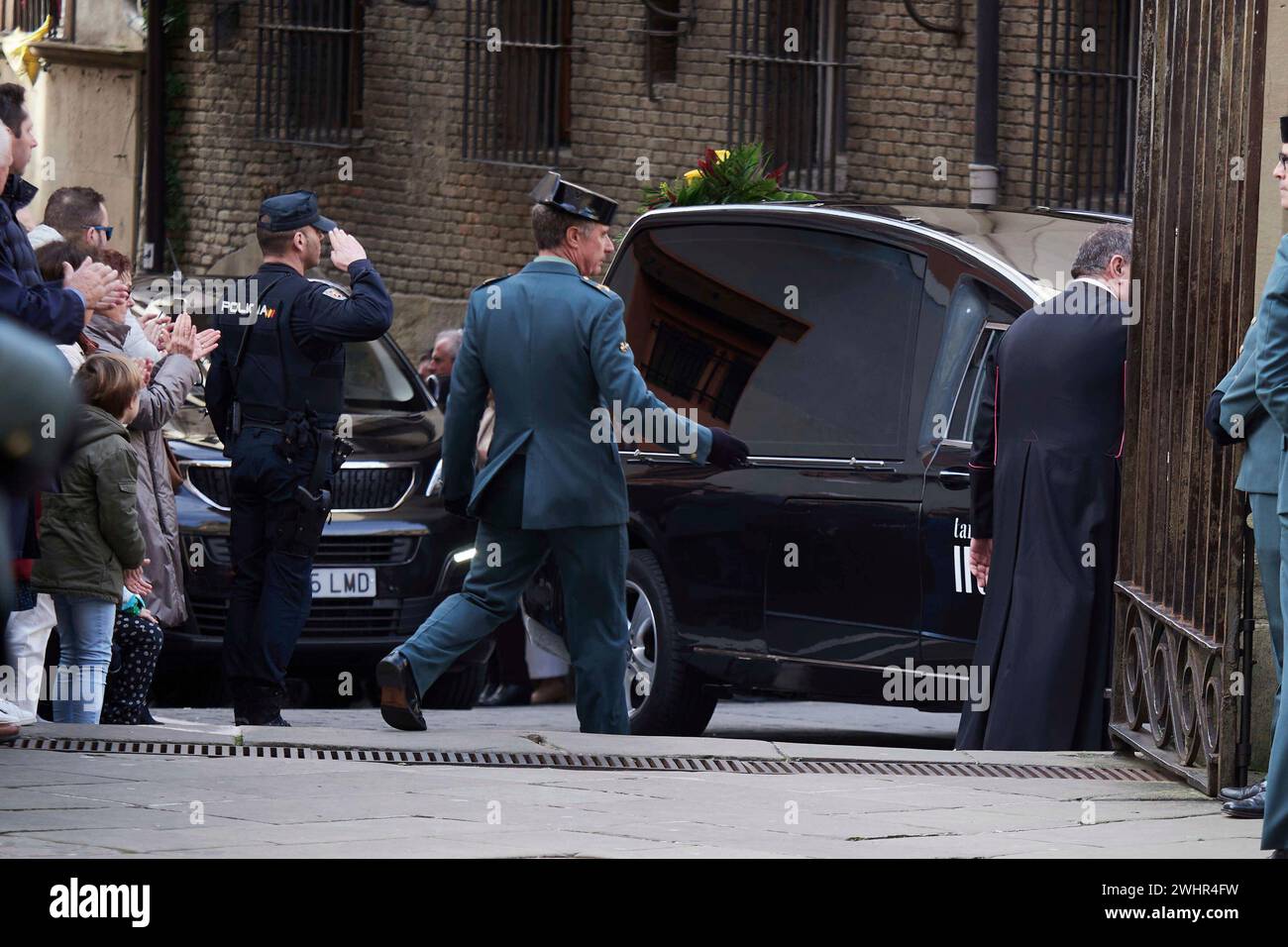 A hearse carries the coffin during the funeral of one of the civil ...
