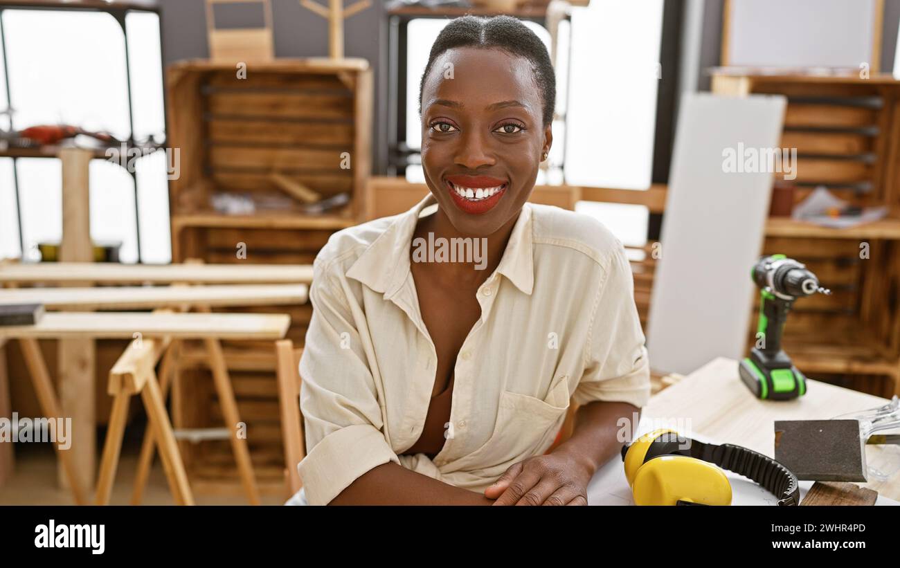 Smiling african american woman carpenter confidently sitting at the ...