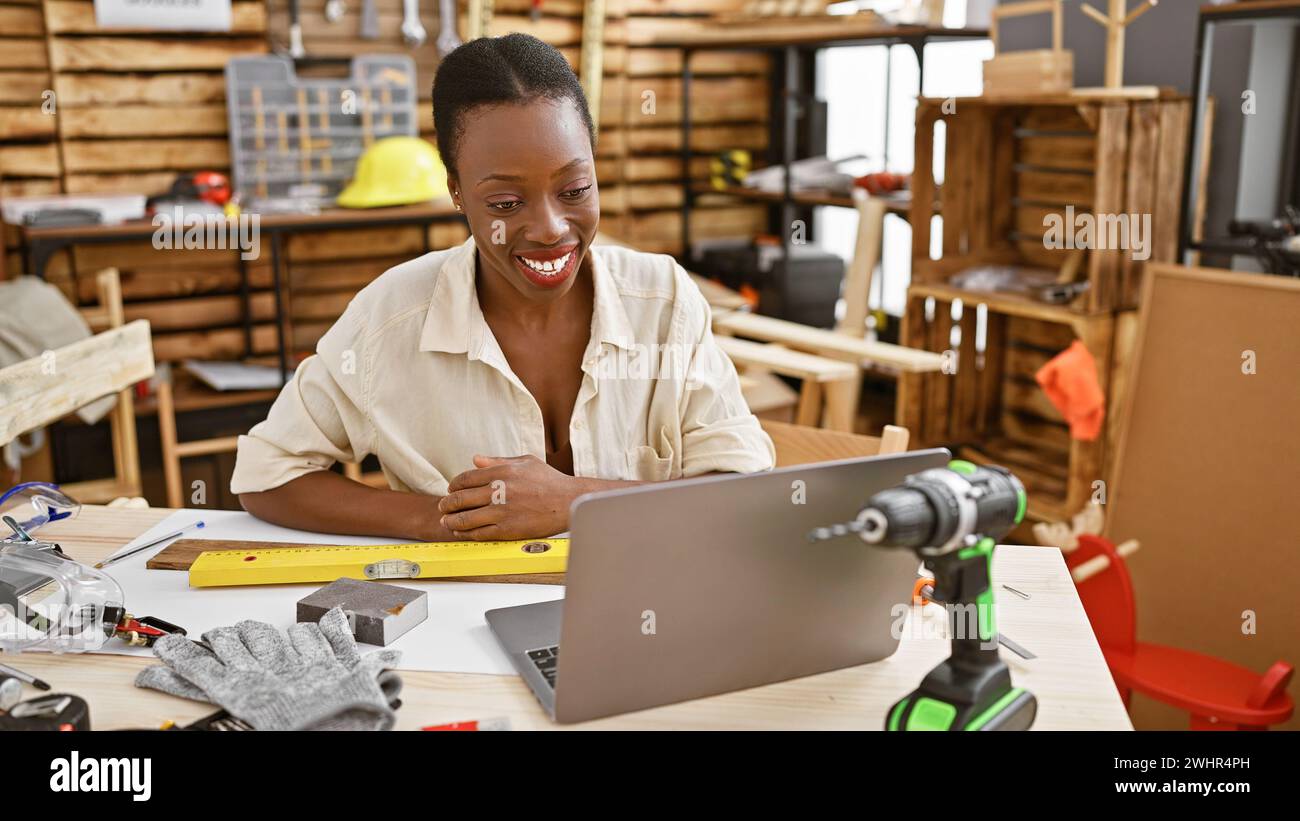 Beautiful african american carpenter woman smiling as she works on her ...