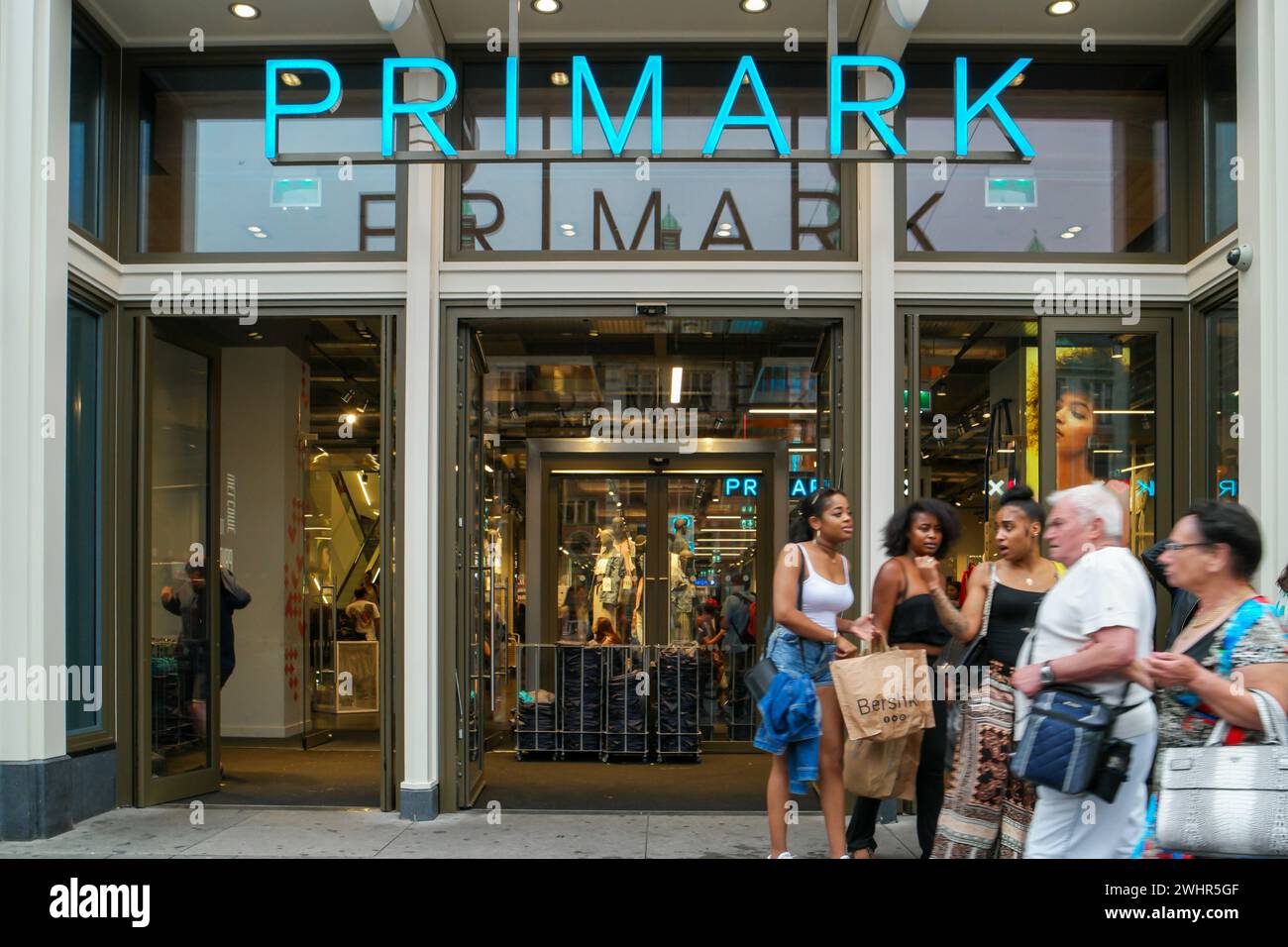 Damrak shopping street on a busy weekend day, Primark sign in front of ...