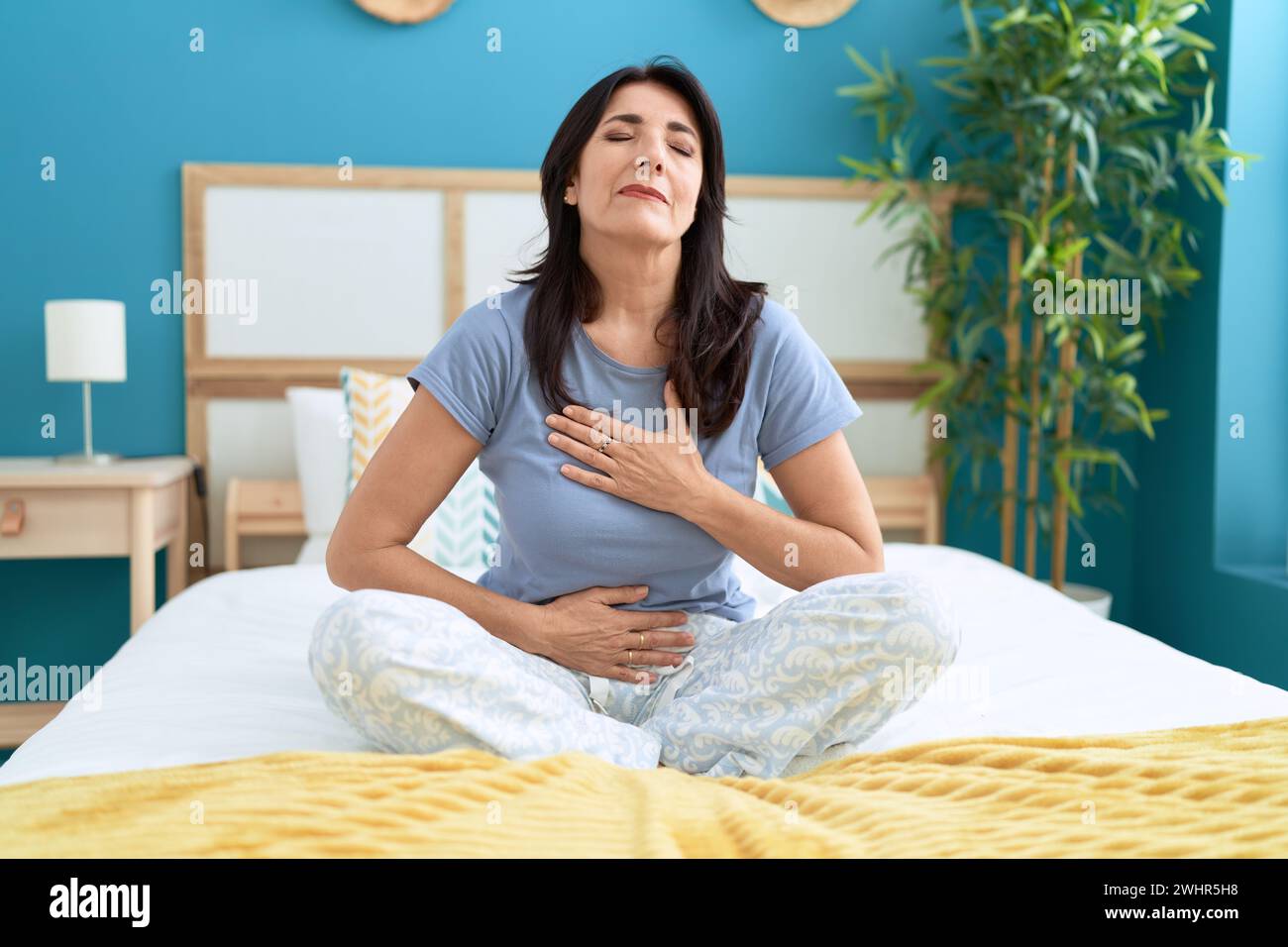 Woman touching chest hi-res stock photography and images - Alamy