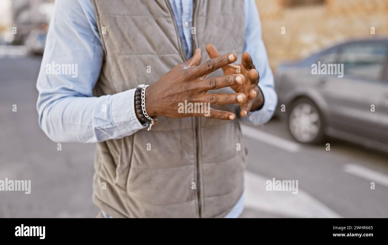 African american man clapping hands on city street with cars in the ...