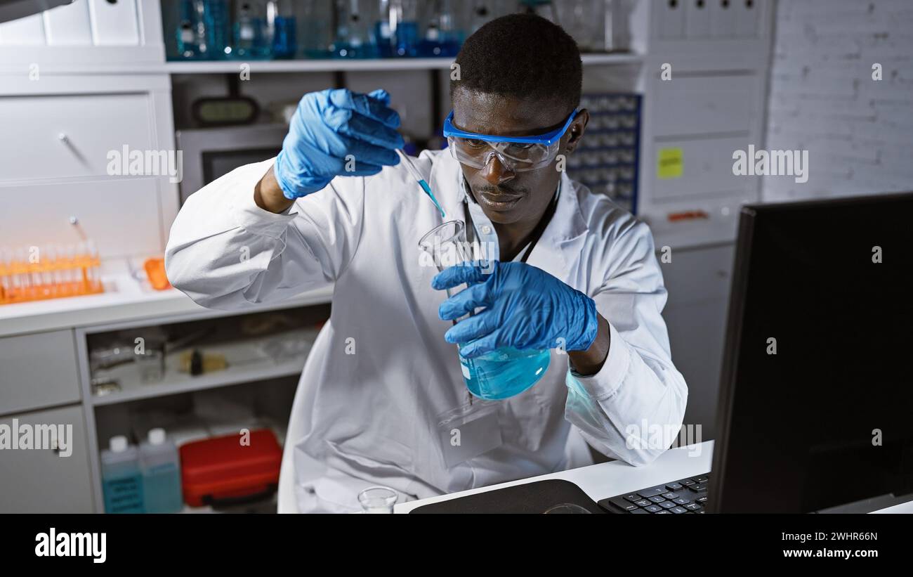 African scientist working with chemicals in a laboratory setting ...
