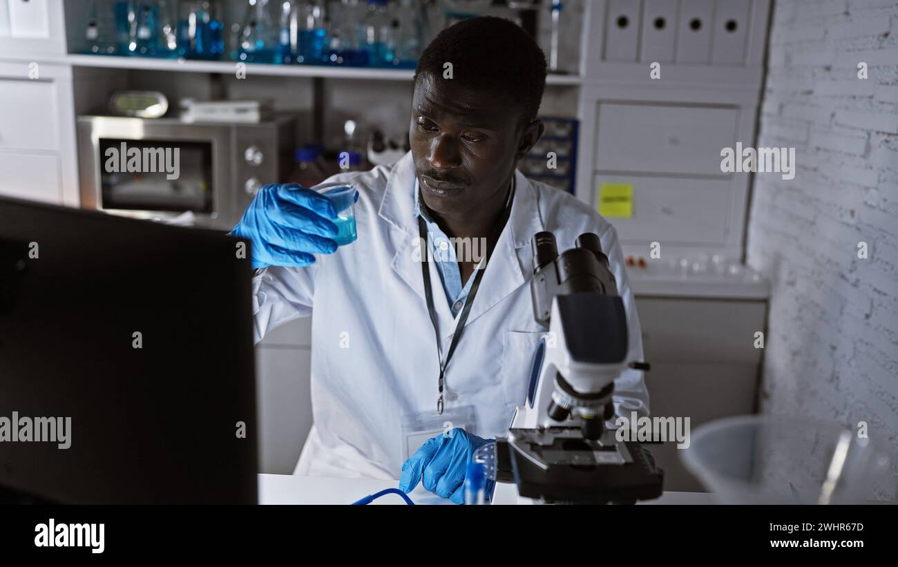 African man scientist analyzing liquid in laboratory Stock Photo - Alamy