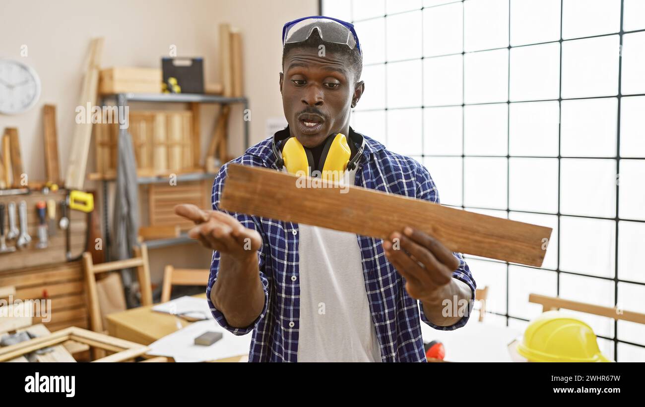African american man examining wood in a carpentry workshop, wearing ...