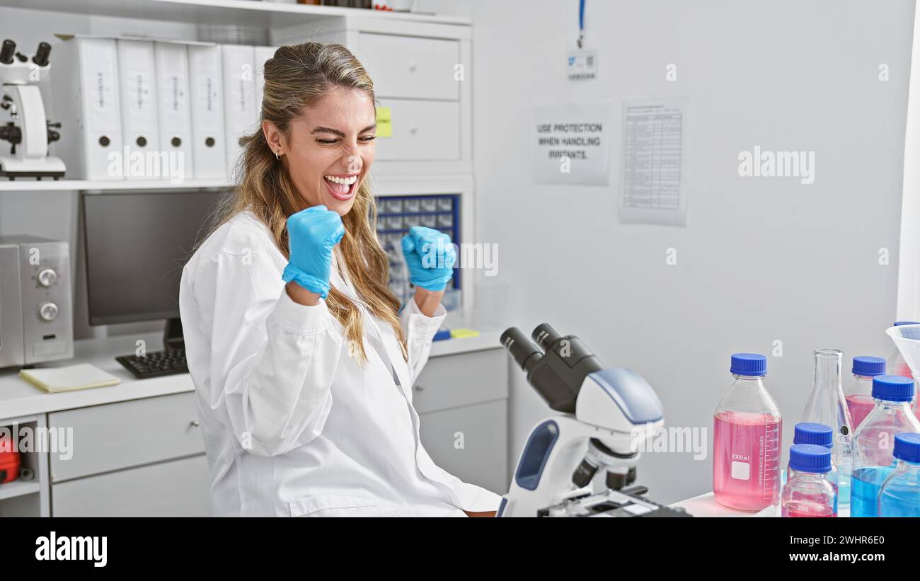 Eureka moment, attractive young blonde woman scientist celebrating ...