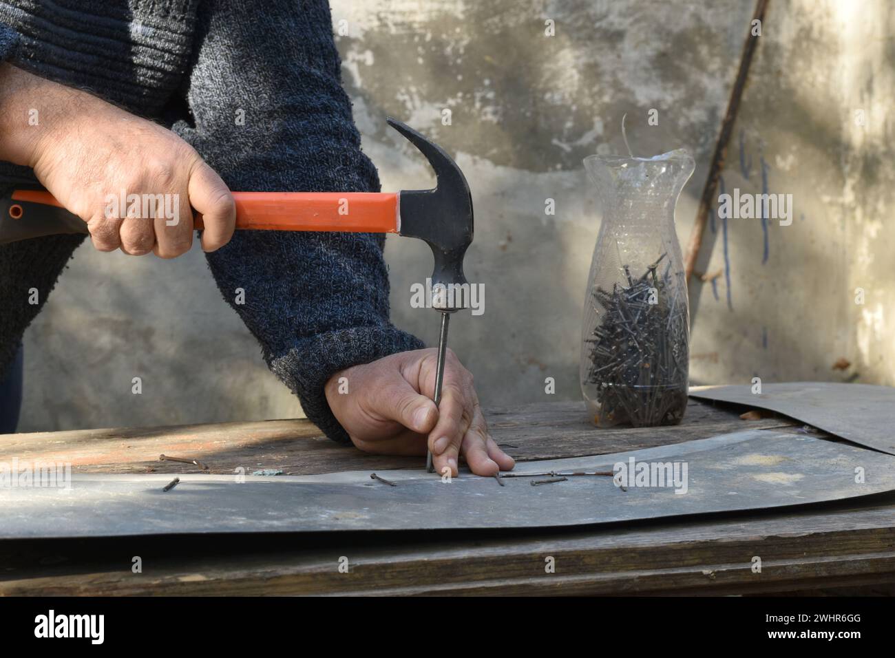 The Picture Shows The Carpenter S Hands With Which He Holds A Hammer