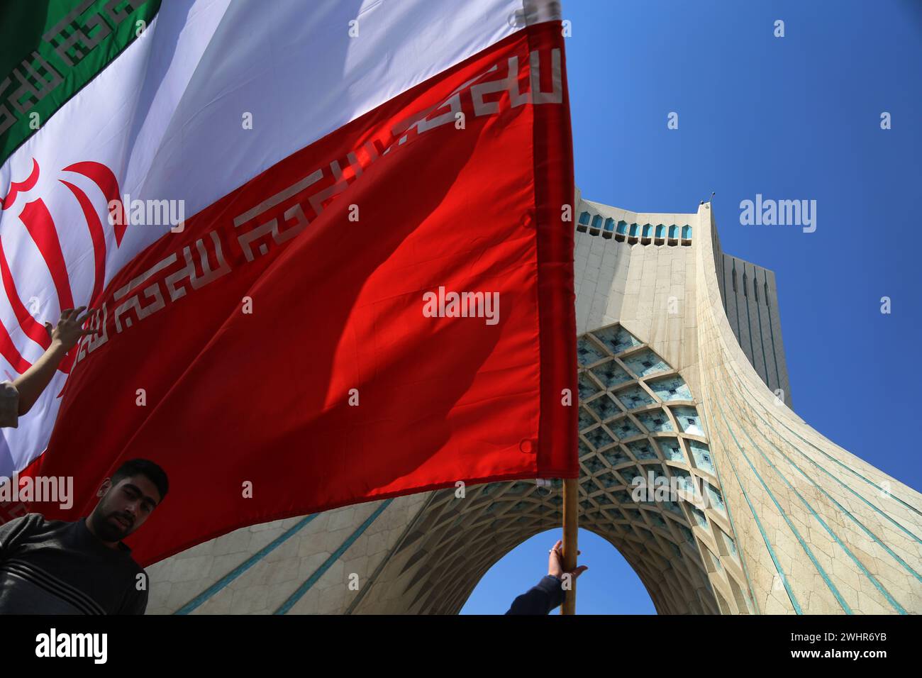 Tehran, Iran. 11th Feb, 2024. Iranians wave a huge Iranian flag at ...
