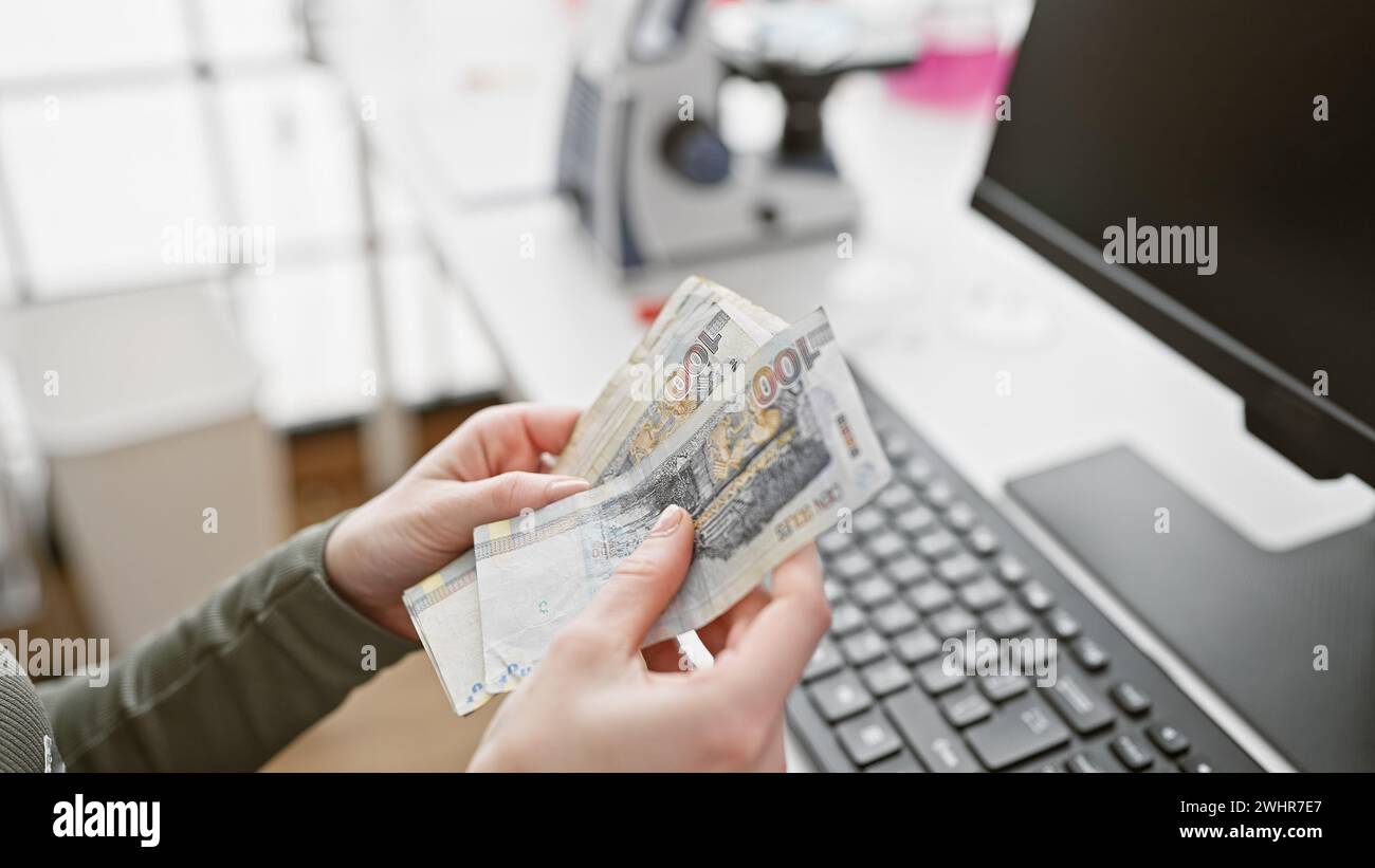 Caucasian woman counts peruvian soles in a modern laboratory setting ...