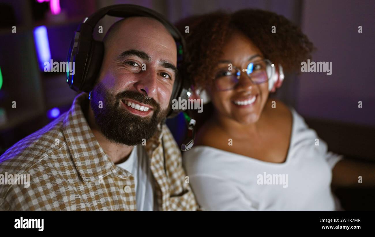 Two happy gamers with a confident smile, gaming together in their ...