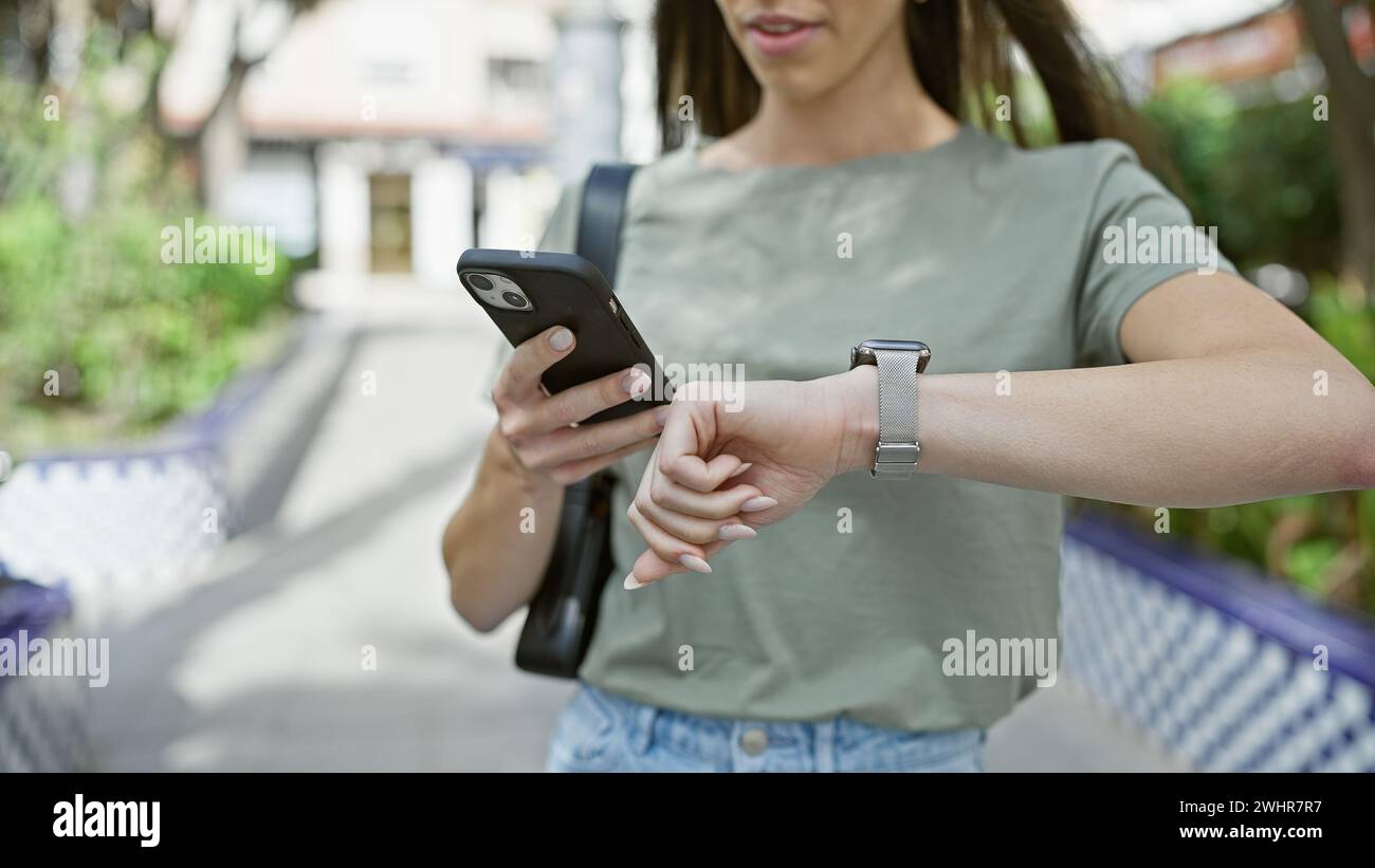 Outdoor shot, woman's hands caught texting time countdown on smartphone ...