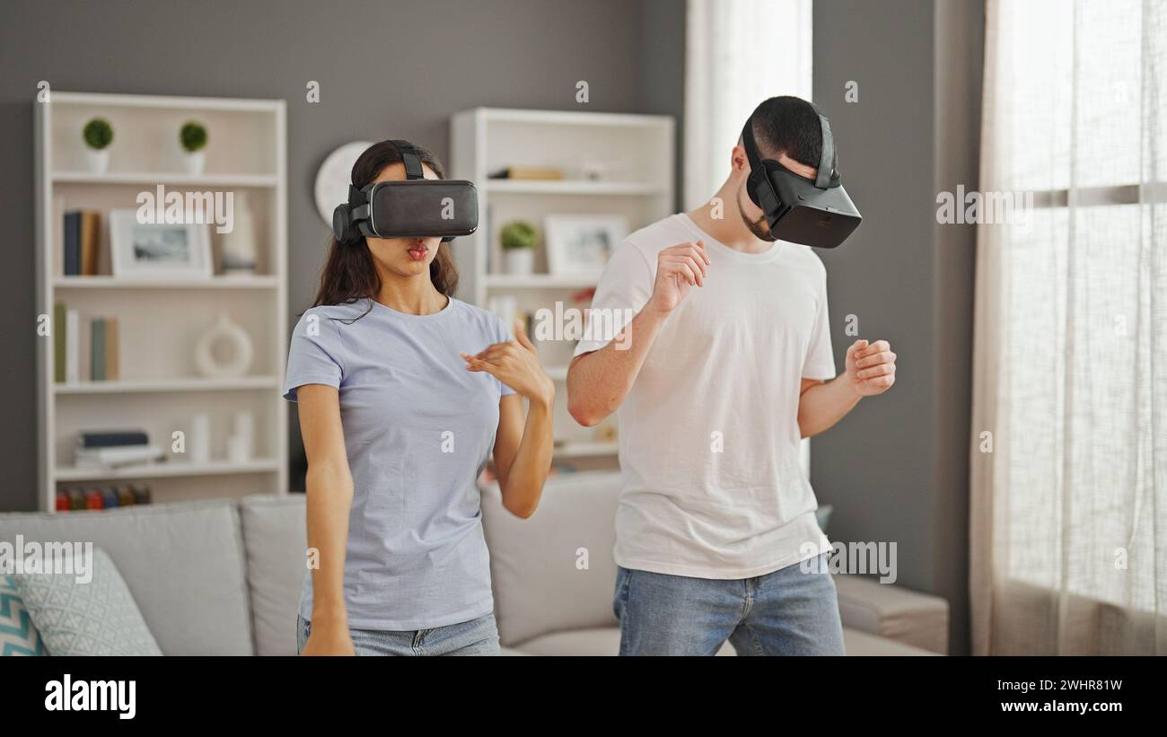 Beautiful couple in love, gaming together at home, using virtual ...
