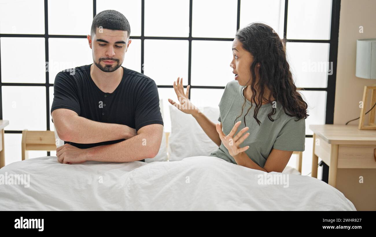 Beautiful couple arguing in bedroom, a serious disagreement amidst a ...