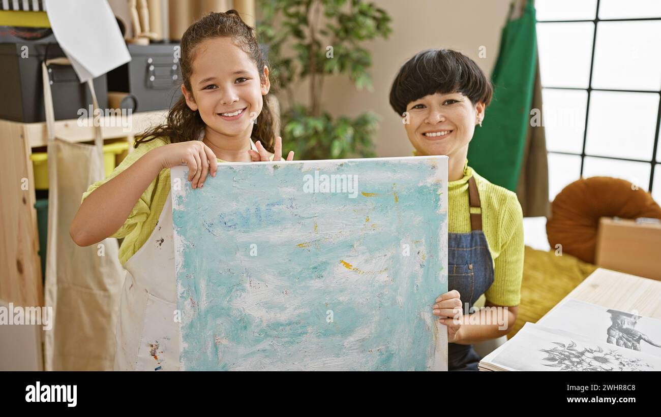 Confident art teacher and student showoff their canvas drawing, smiling ...