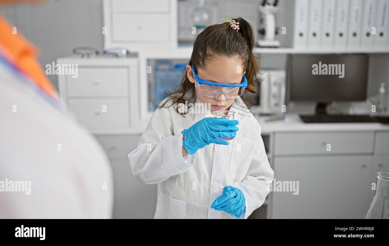 Two dedicated scientists, working intensely together in a laboratory ...