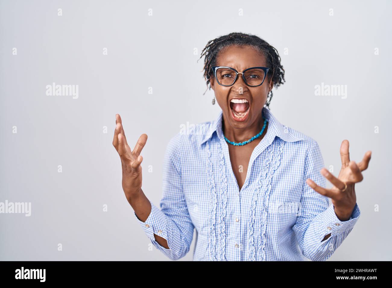 African woman with dreadlocks standing over white background wearing ...