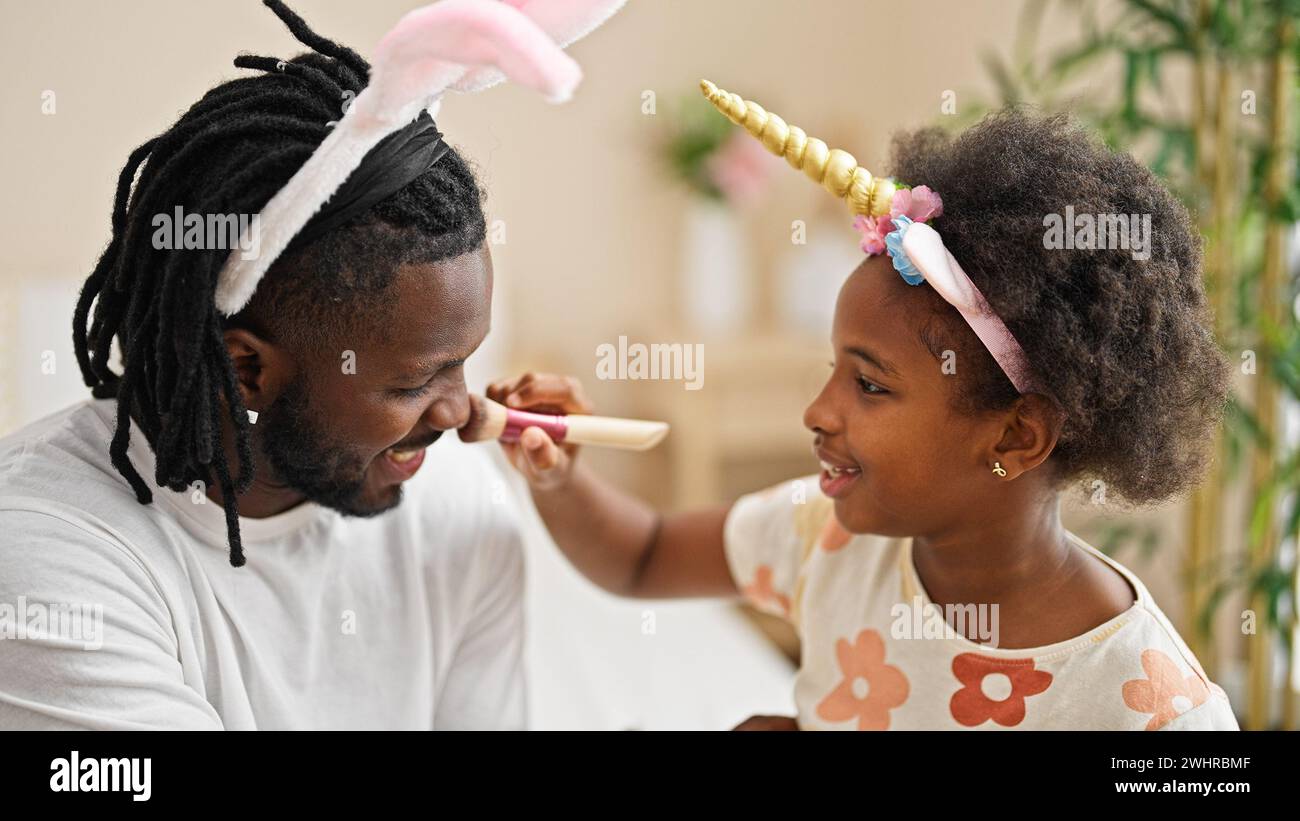 African american father and daughter wearing funny diadem applying ...