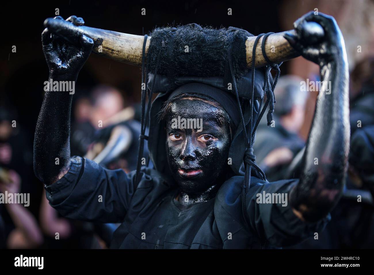 A girl dressed to represent the devil dons bull horns with her face ...