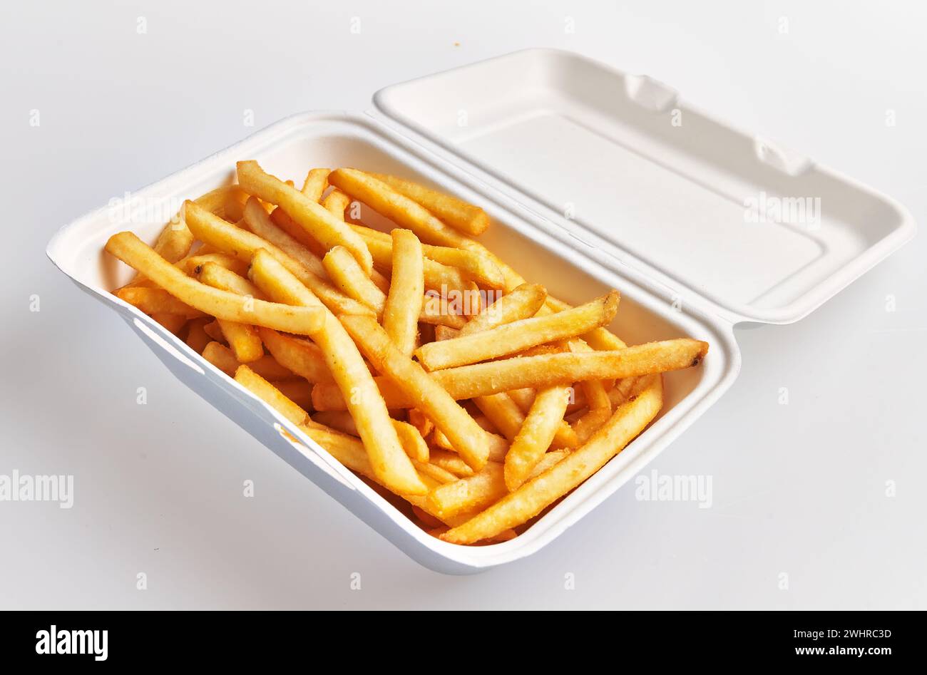 Close-up of golden french fries in a white styrofoam container set ...