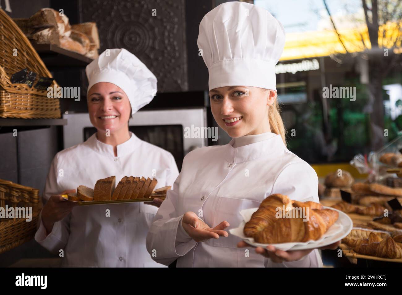 Women workers in a bakery posing with pastries Stock Photo - Alamy