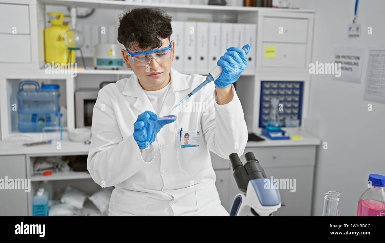 A man in a white lab coat meticulously pipetting liquid into a test ...