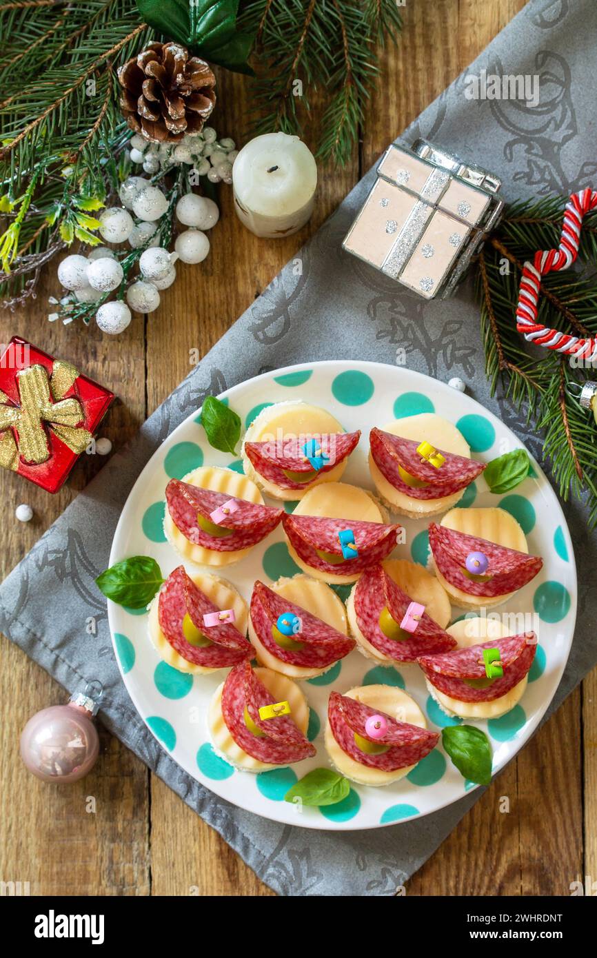 Festive snack of canapes on the Christmas table. Canapes with bread ...