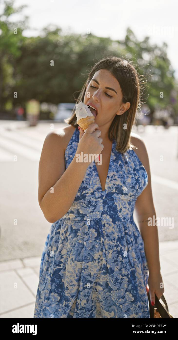 Summertime delight, beautiful hispanic woman enjoying delicious ice ...