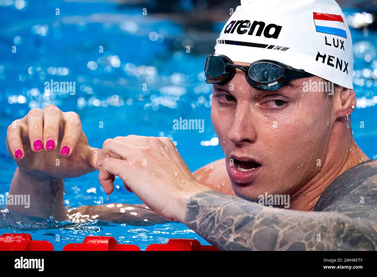 Julien Henx of Luxembourg competes in the swimming men's 50m butterfly ...