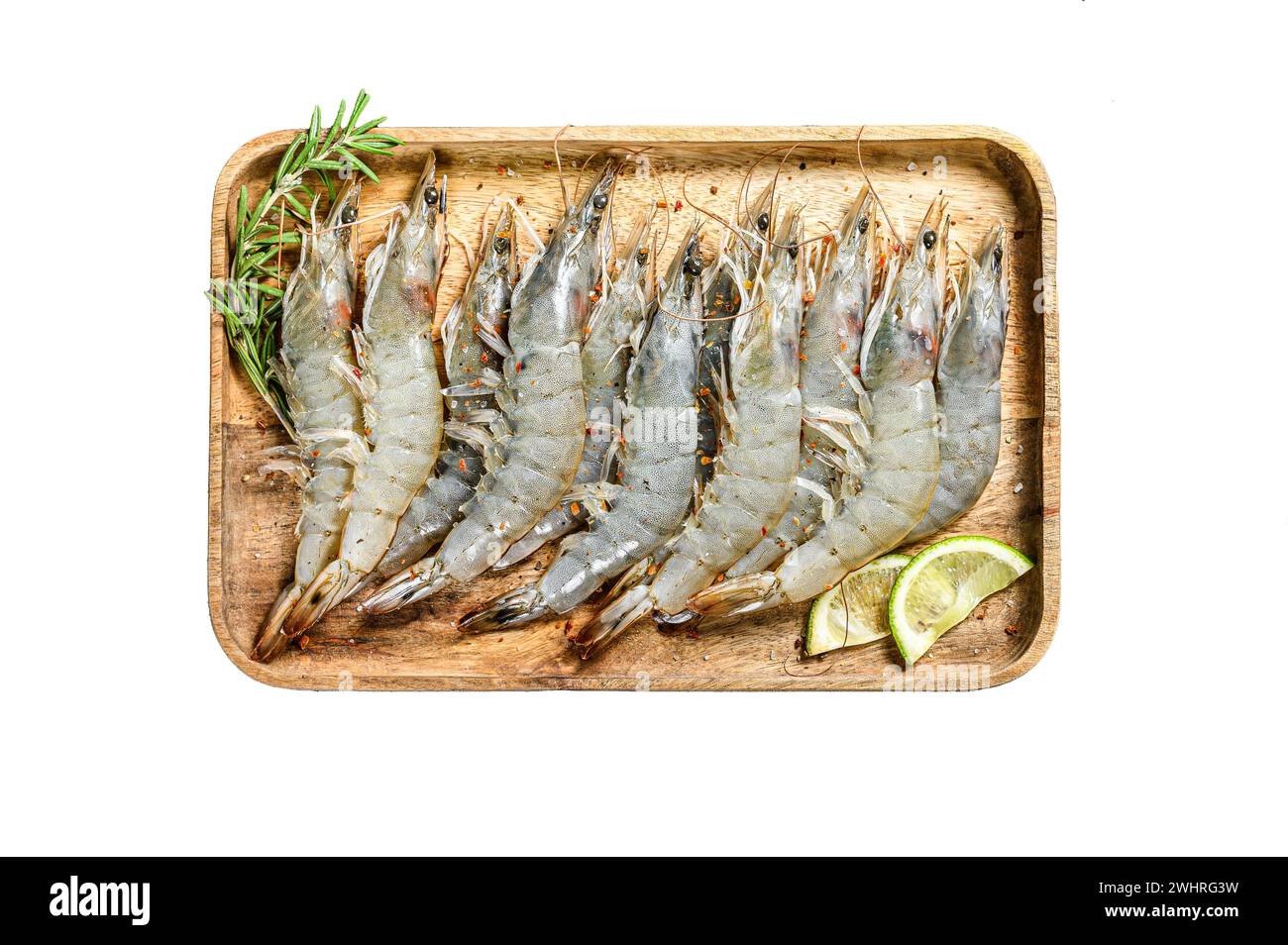 Whole fresh raw langoustine prawns, shrimps on a wooden tray. Isolated ...