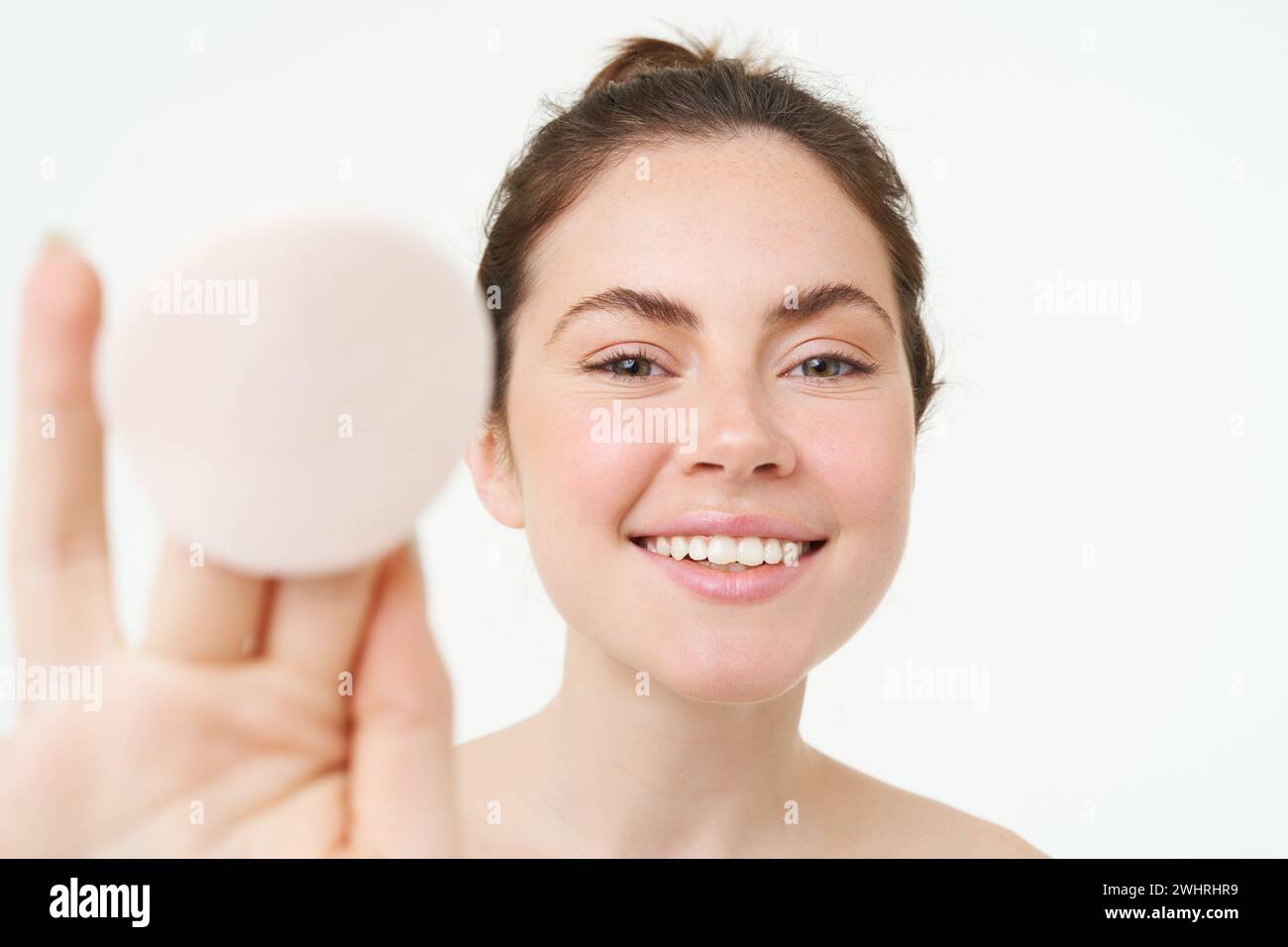 Skincare and wellbeing. Young woman shows cosmetic cotton pad, takes ...