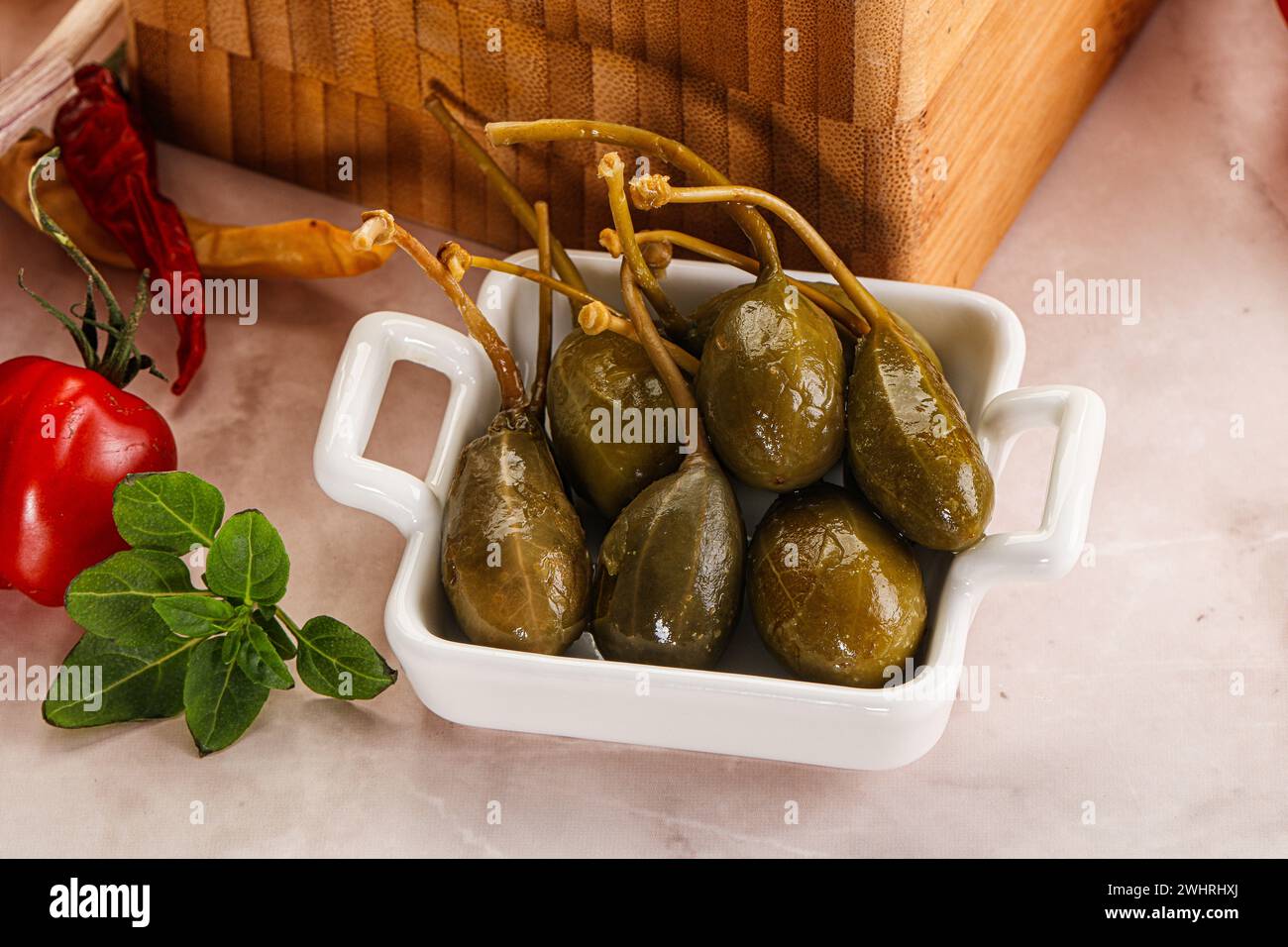Marinated Caper Berries snack appetiser in the bowl Stock Photo - Alamy