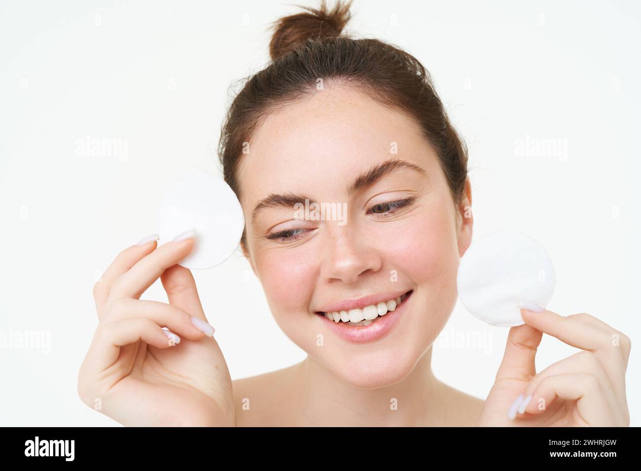 Beauty woman with clear glowing face, showing cotton cosmetic pads for ...