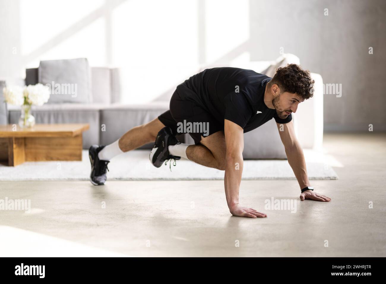 Sporty young guy doing flexibility exercises at home, banner Stock ...