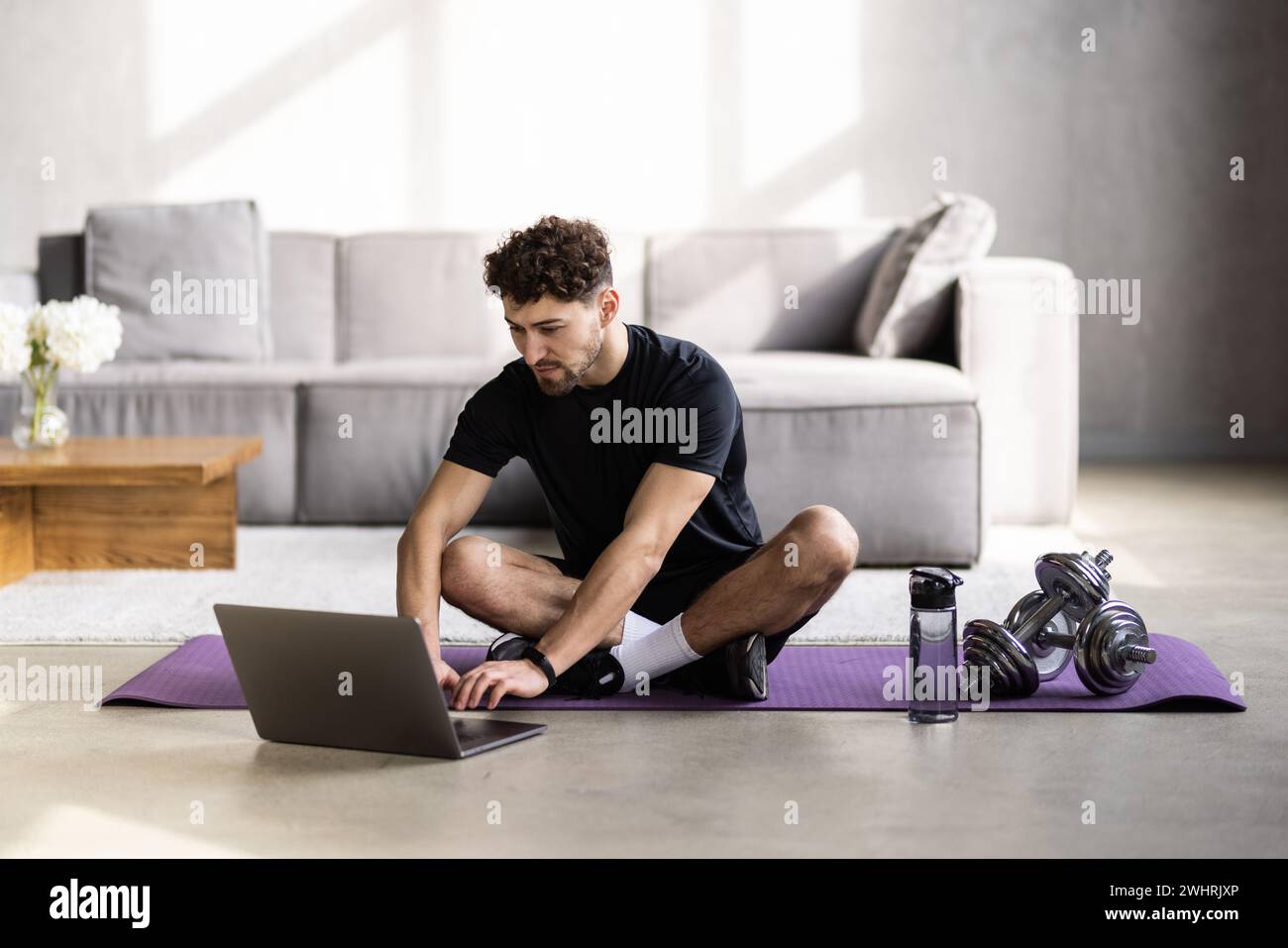 Cheerful stretching. Male fitness instructor showing exercises while ...